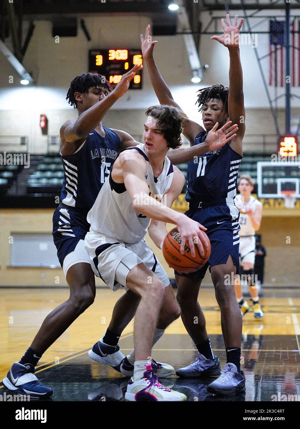 A vertical of athletic basketball players competing for the ball ...