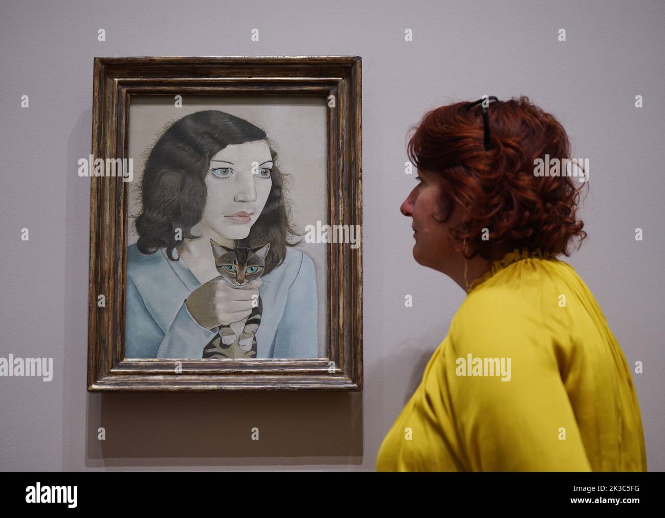 A gallery staff member poses next to a painting by Lucian Freud - Girl ...