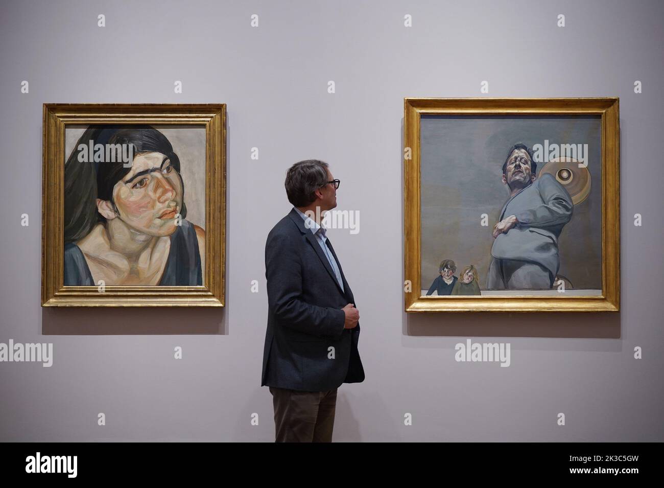 A gallery staff member poses next to paintings by Lucian Freud (L-R ...