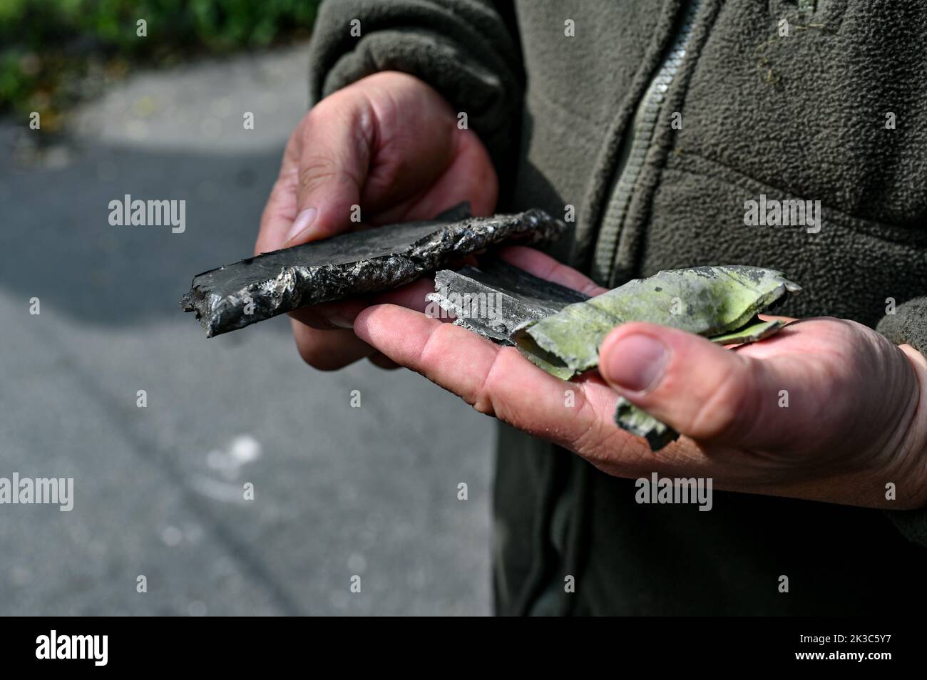 ZAPORIZHZHIA, UKRAINE - SEPTEMBER 24, 2022 - A man holds the fragments ...
