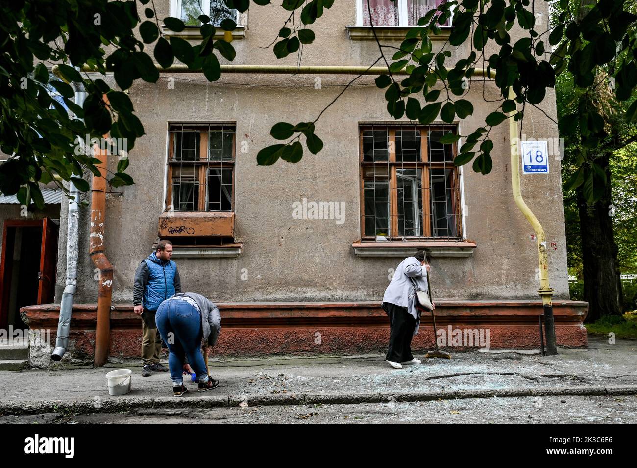 ZAPORIZHZHIA, UKRAINE - SEPTEMBER 24, 2022 - People remove the shards ...