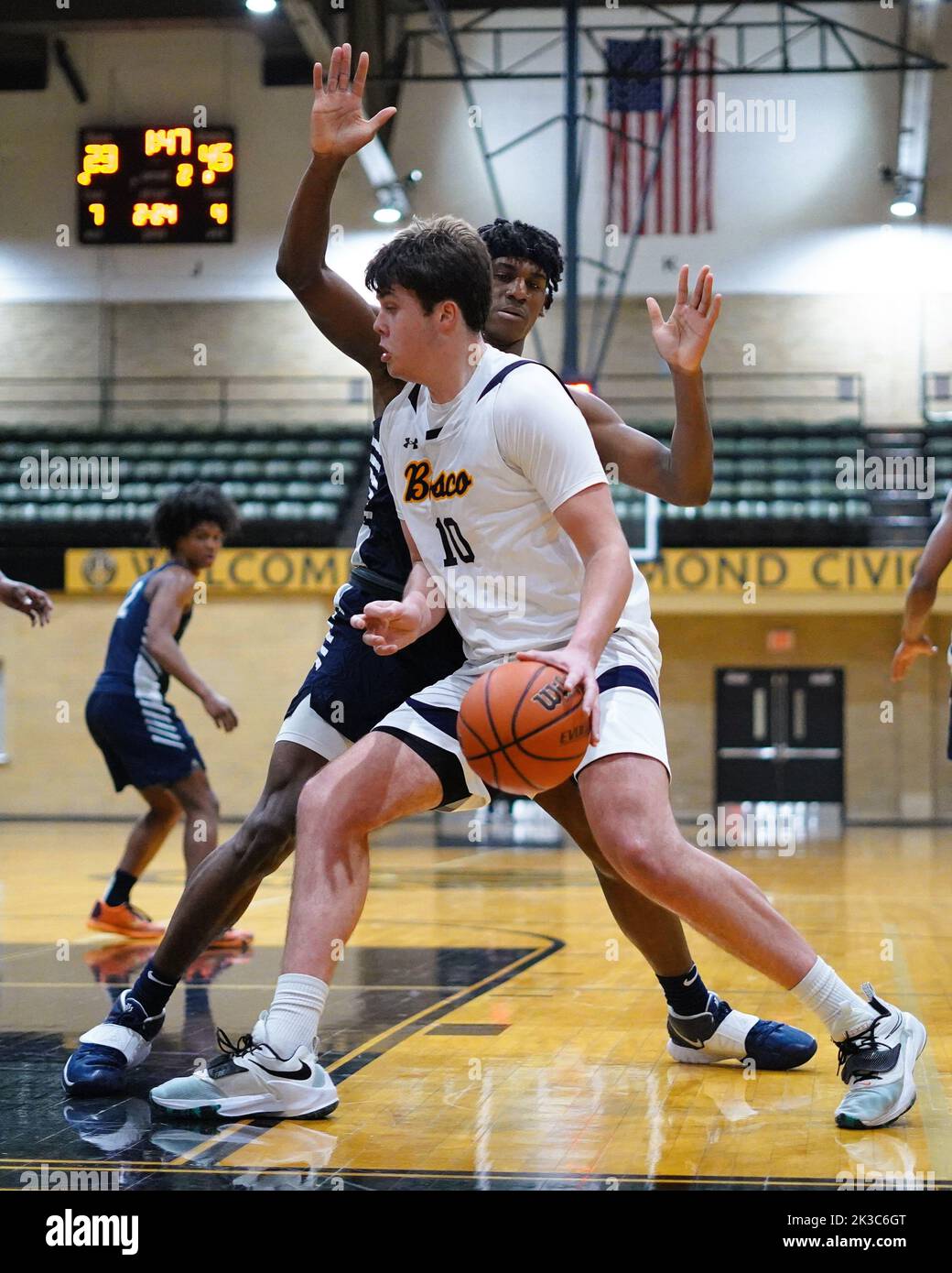 A vertical of athletic basketball players competing for the ball ...