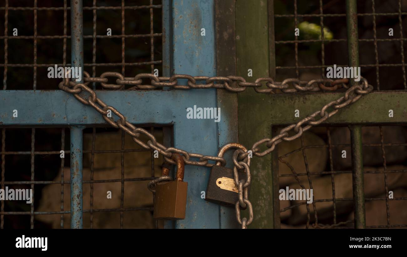 Chained and locked door, protection and security idea, rusty chain and ...