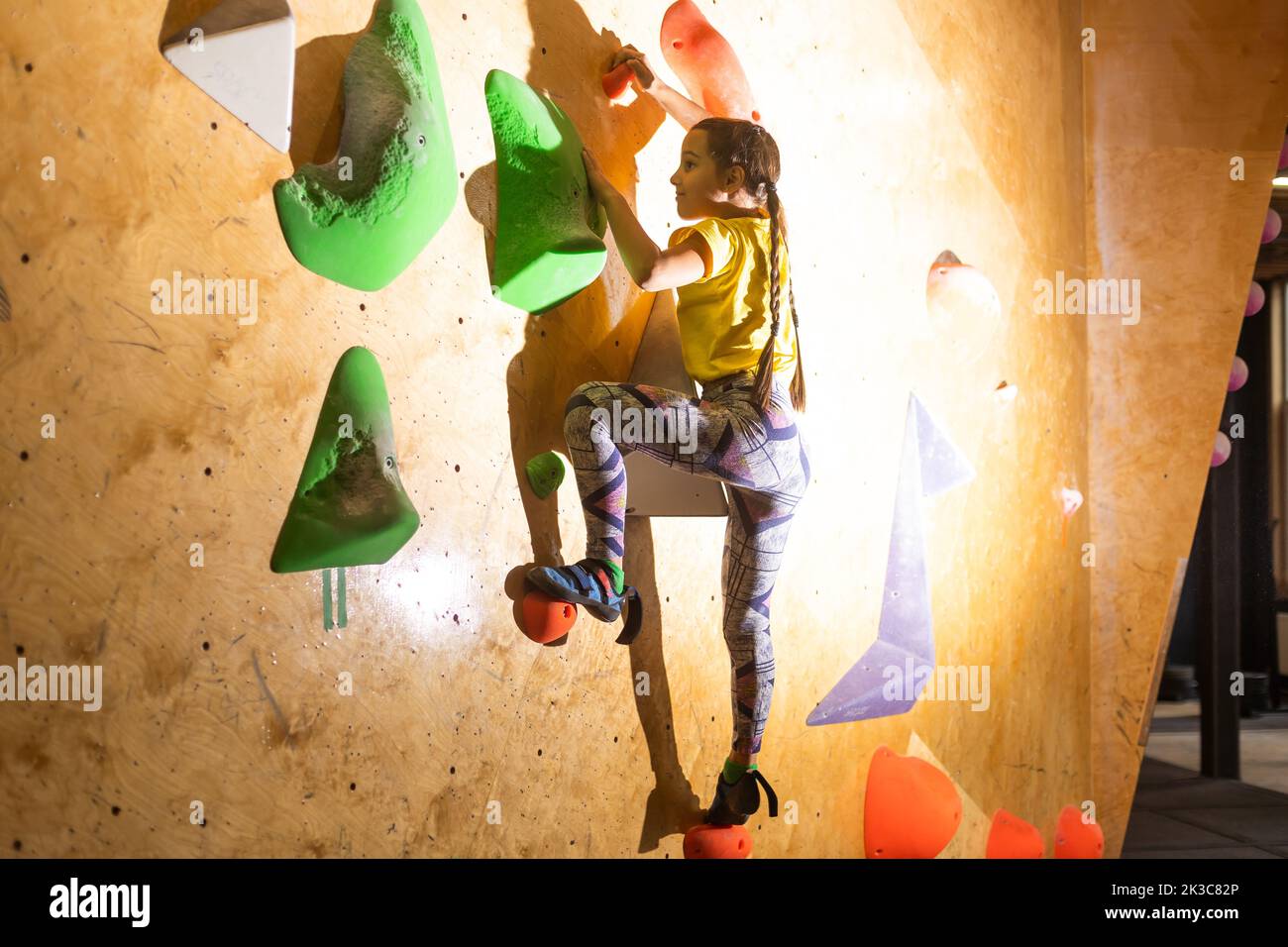 bouldering, little girl climbing up the wall Stock Photo - Alamy