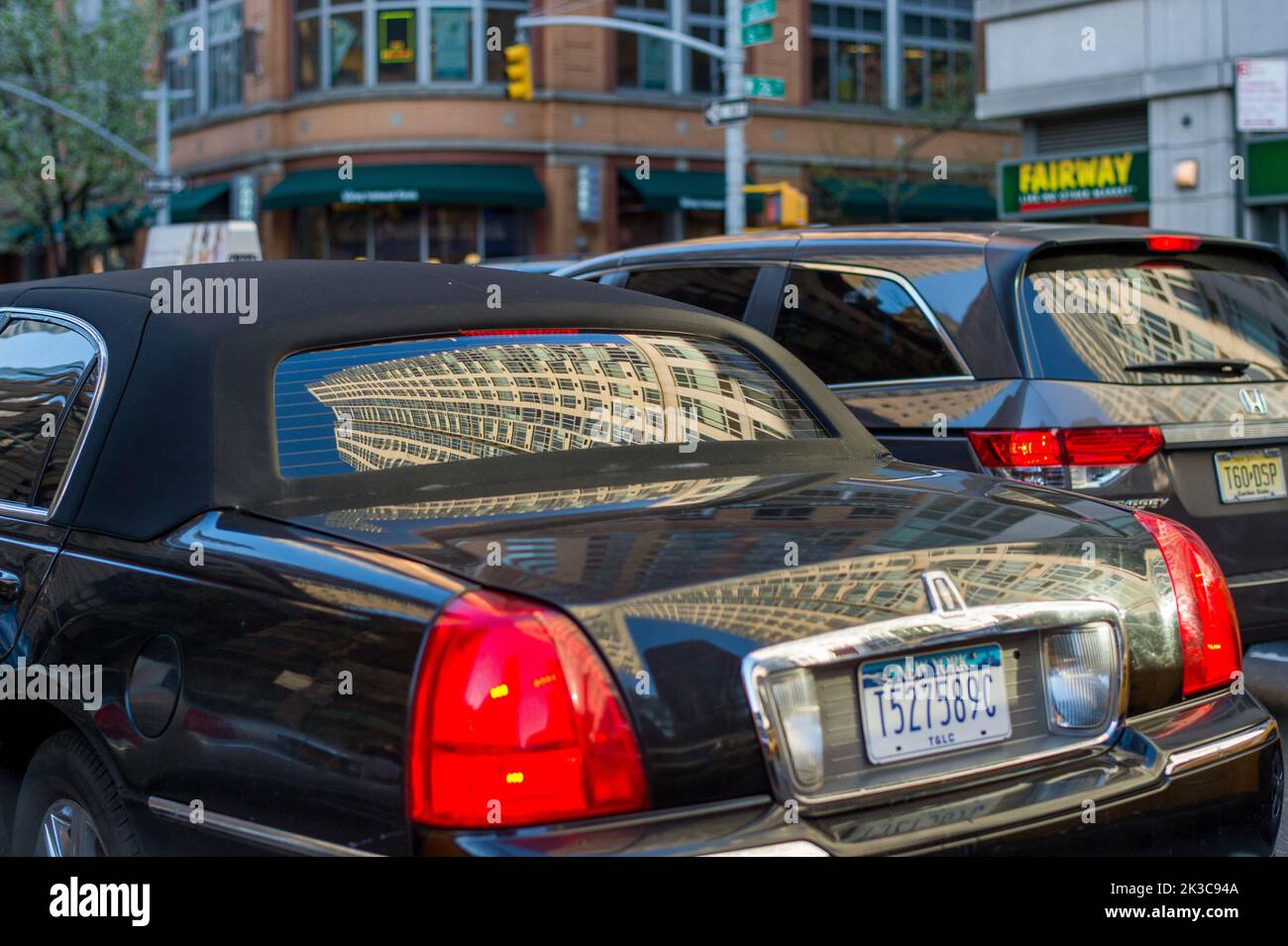 Reflection of a skyscraper in a limousine window at Midtown Manhattan ...