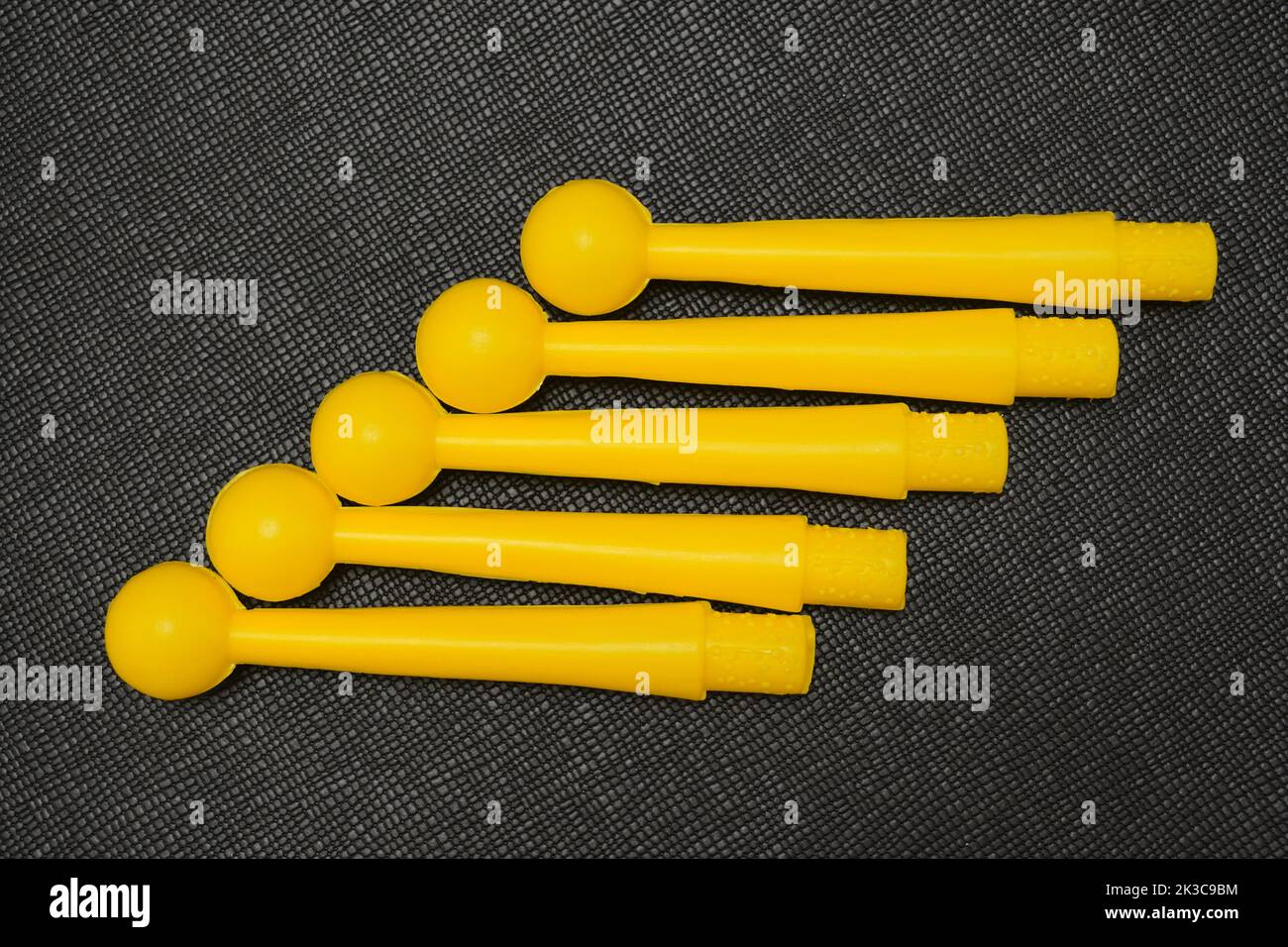 Creative insemination concept, yellow toy sticks representing sperm ...