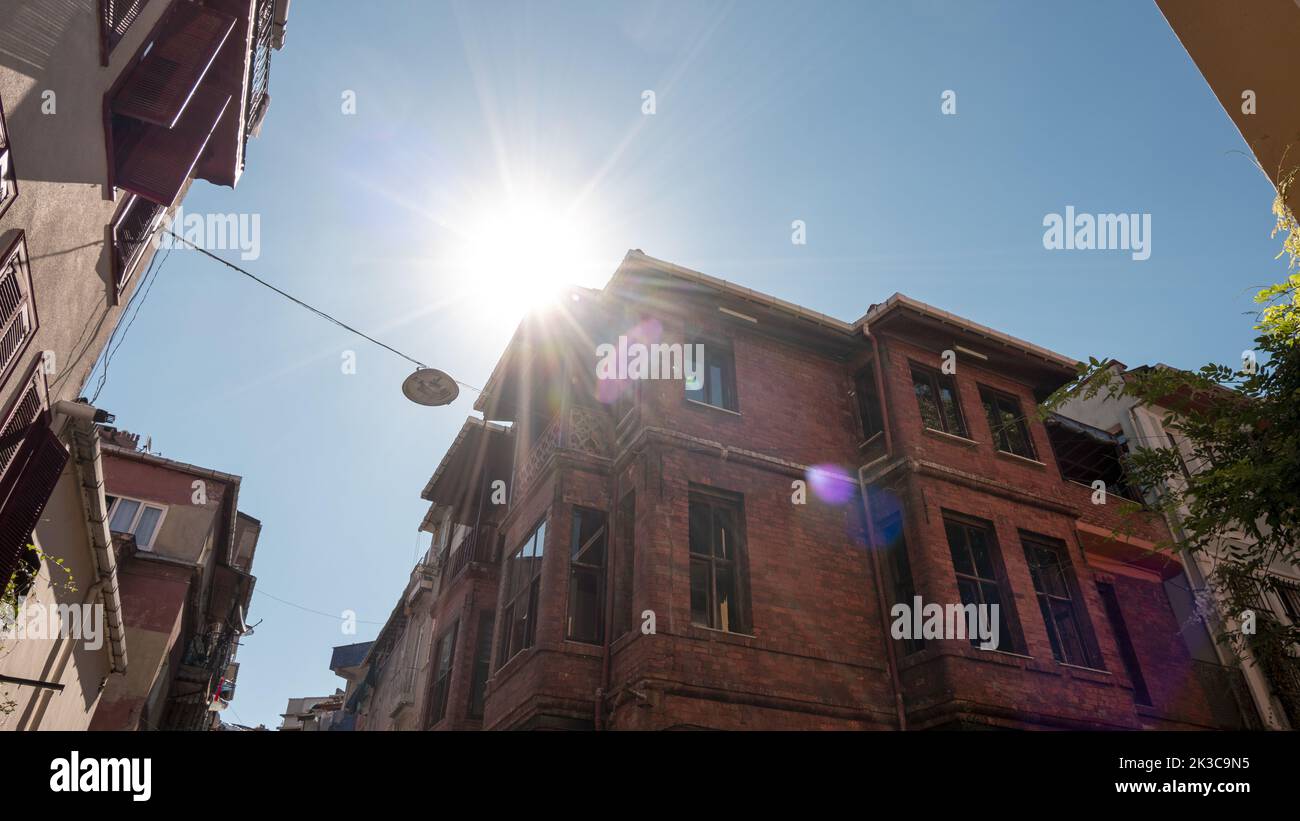 Sunbeam appears from top of old brick detached house, landmark with sun ...