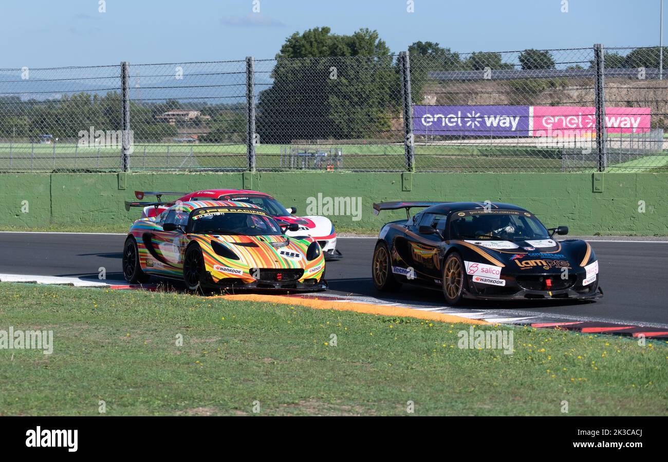 Lotus Exige race cars challenge overtaking on racetrack. Vallelunga 10 ...