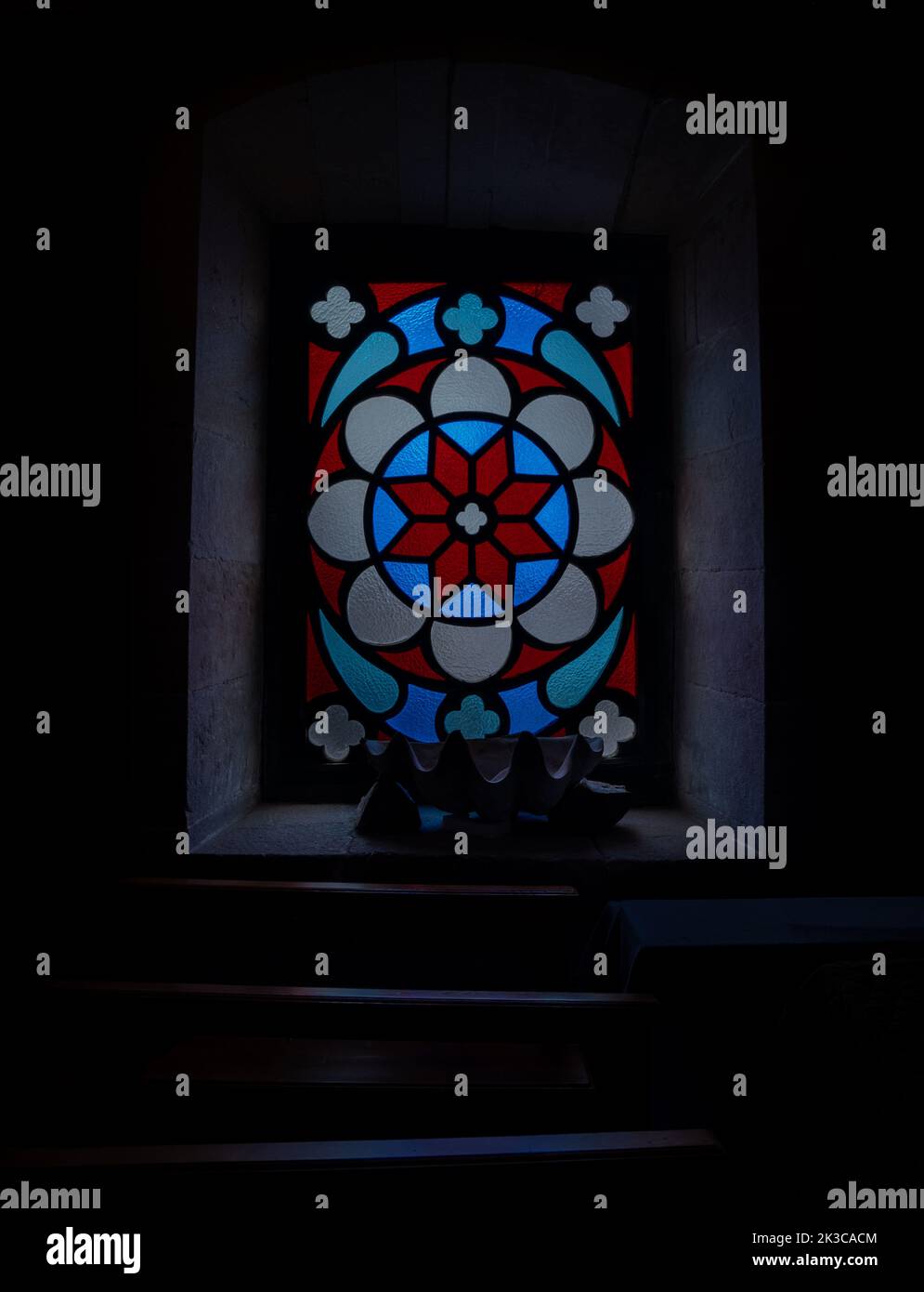 Dimly lit stained glass window of a church Stock Photo - Alamy