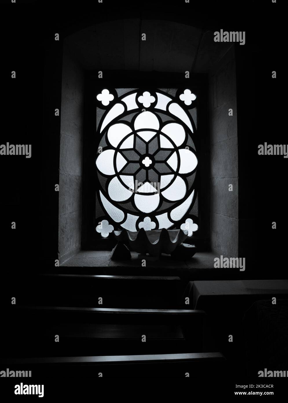 Dimly lit stained glass window of a church Stock Photo - Alamy