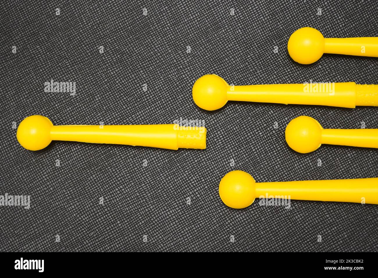 Creative insemination concept, yellow toy sticks representing sperm ...