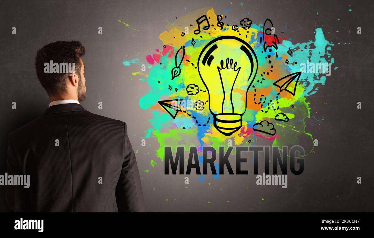 businessman drawing colorful light bulb Stock Photo - Alamy