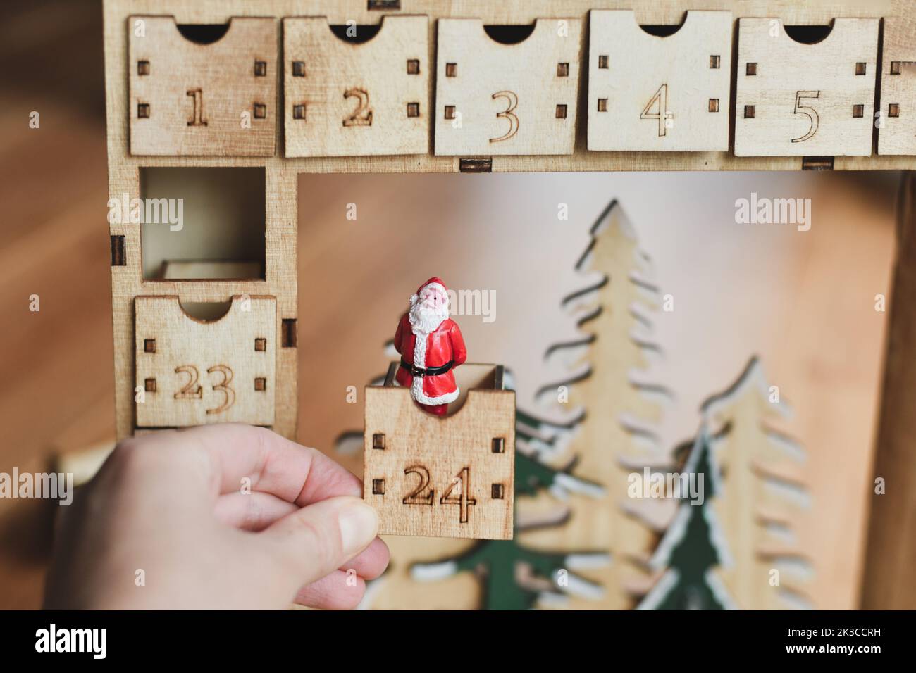 Hand opens wooden advent calendar Stock Photo - Alamy