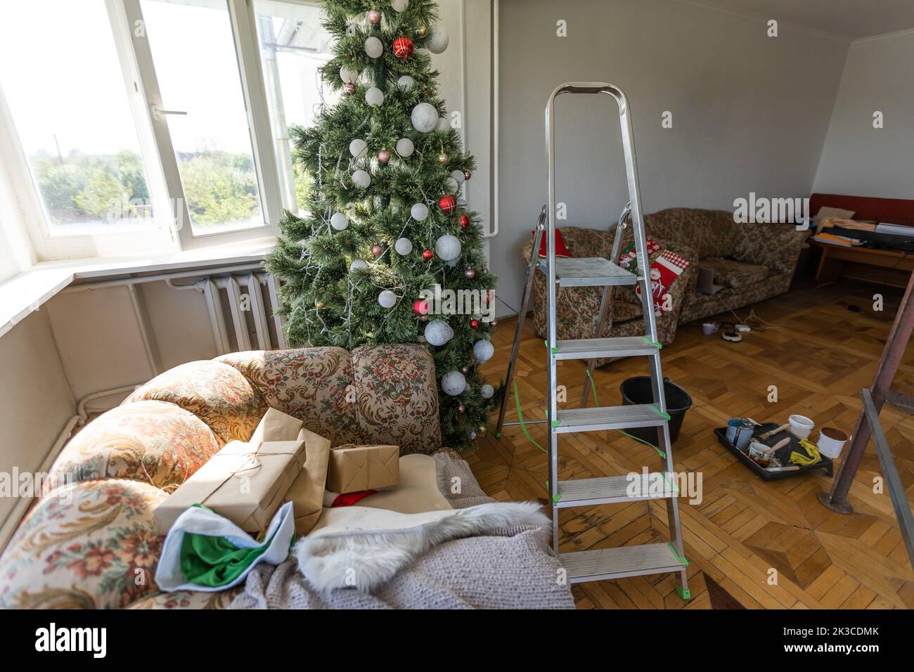 high angle view of christmas tree with messy boxes on floor of new ...