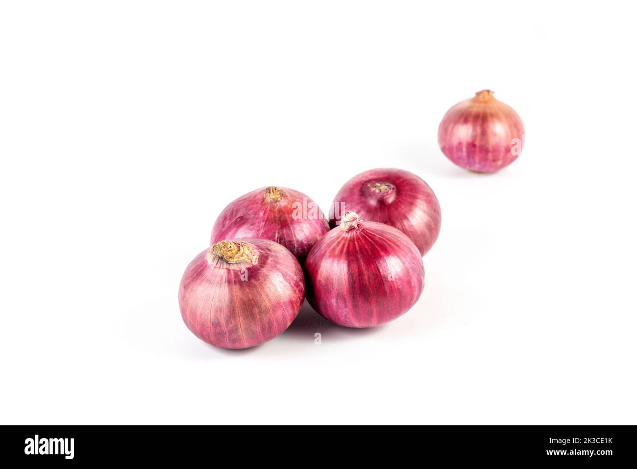 Red onion has peel isolated on white background Stock Photo - Alamy