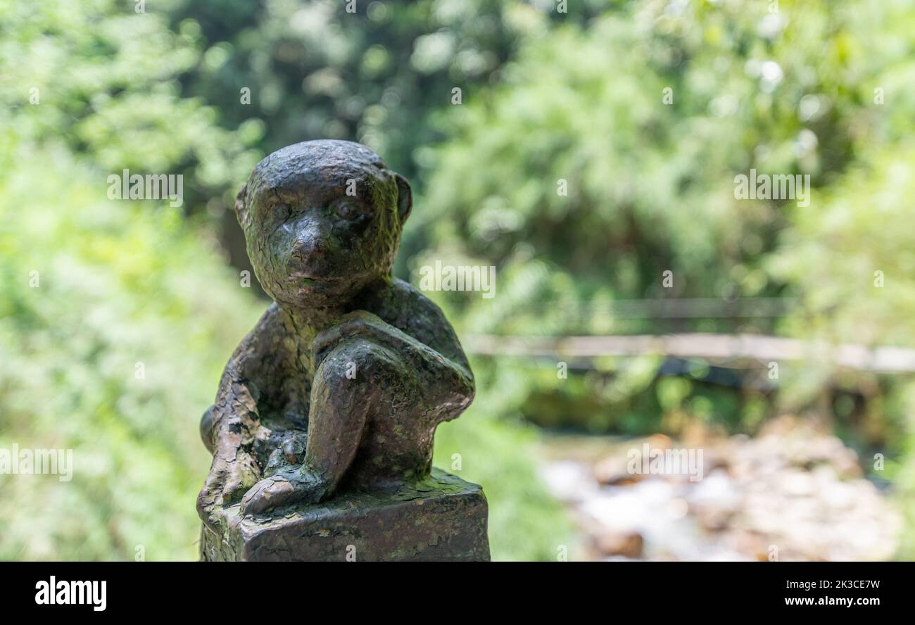 A monkey statue along a mountain road in Mount Emei, China Stock Photo ...