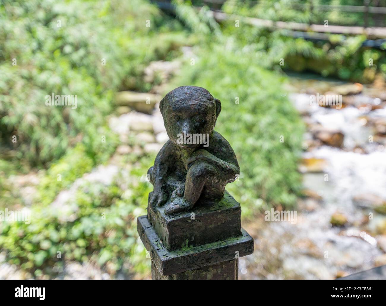A monkey statue along a mountain road in Mount Emei, China Stock Photo ...