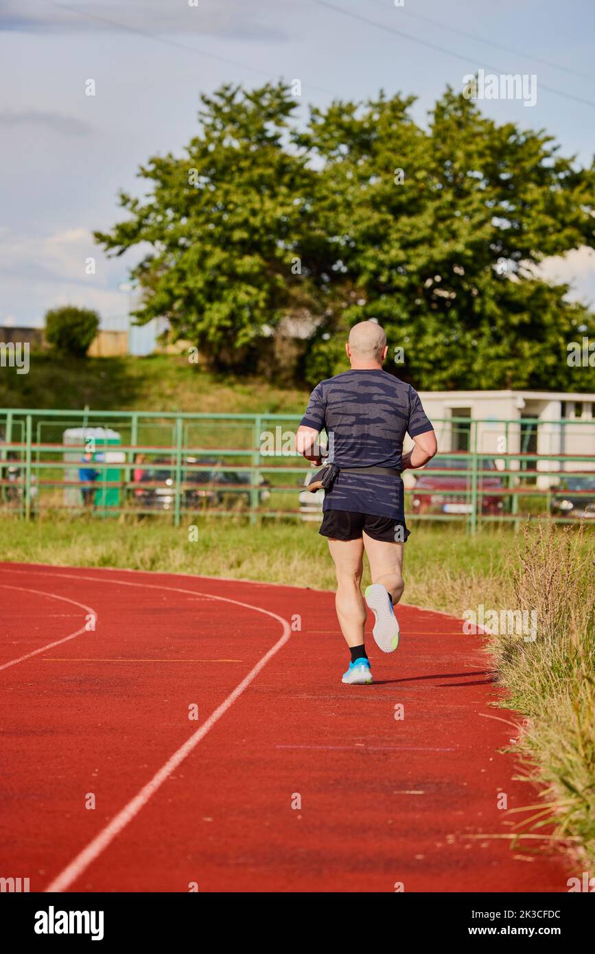 A man running on a running track Stock Photo - Alamy