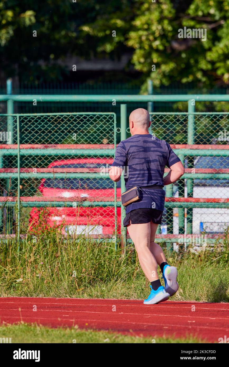 A man running on a running track Stock Photo - Alamy
