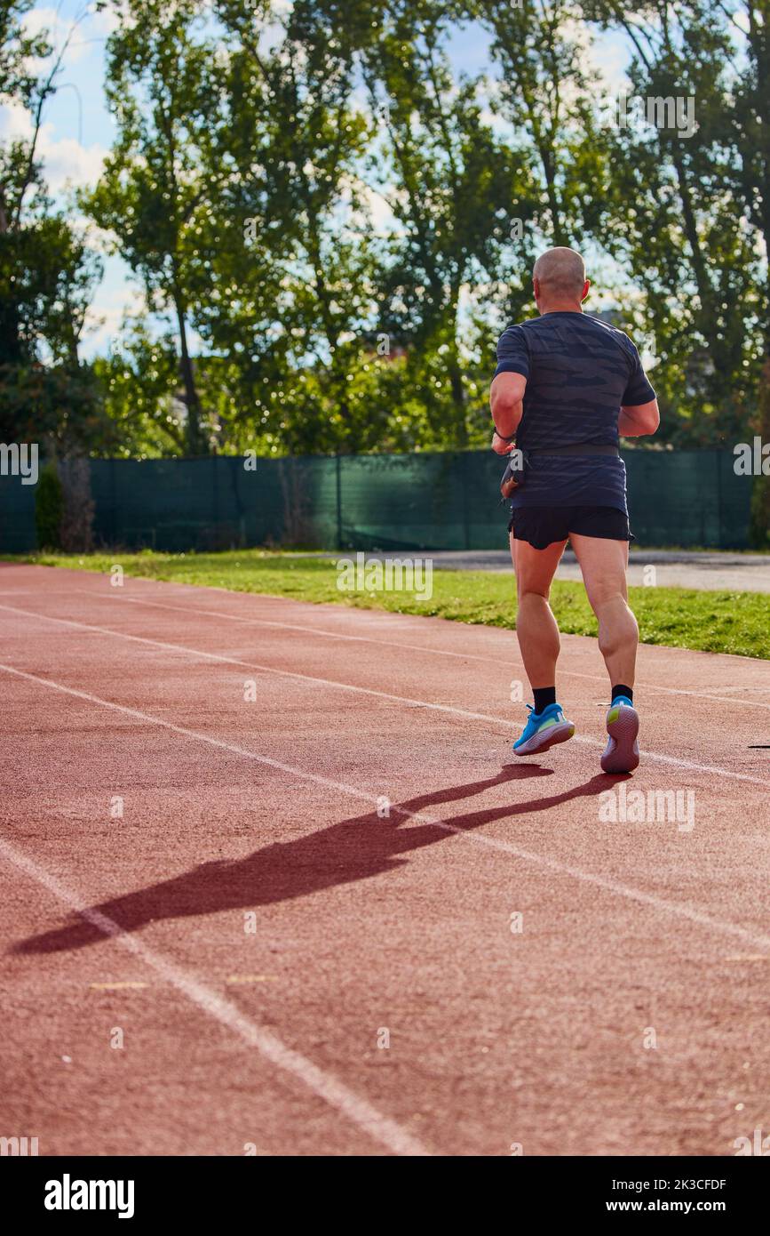A man running on a running track Stock Photo - Alamy