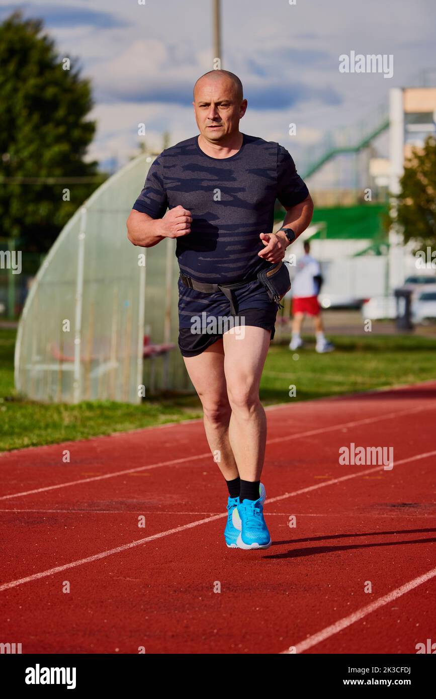 A man running on a running track Stock Photo - Alamy