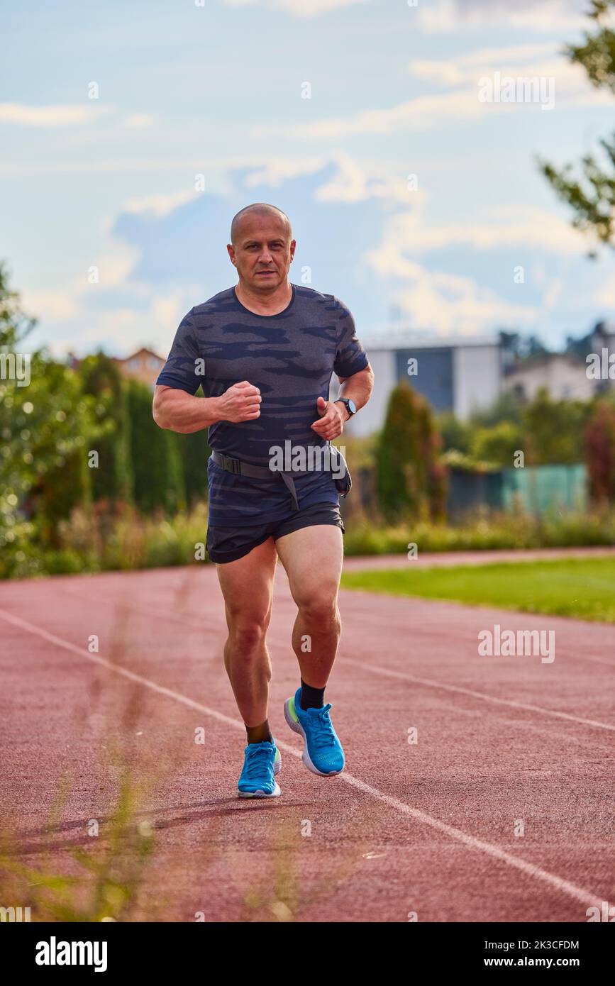 A man running on a running track Stock Photo - Alamy