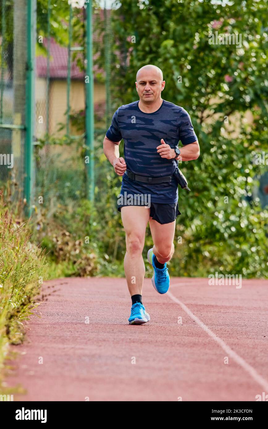 A man running on a running track Stock Photo - Alamy