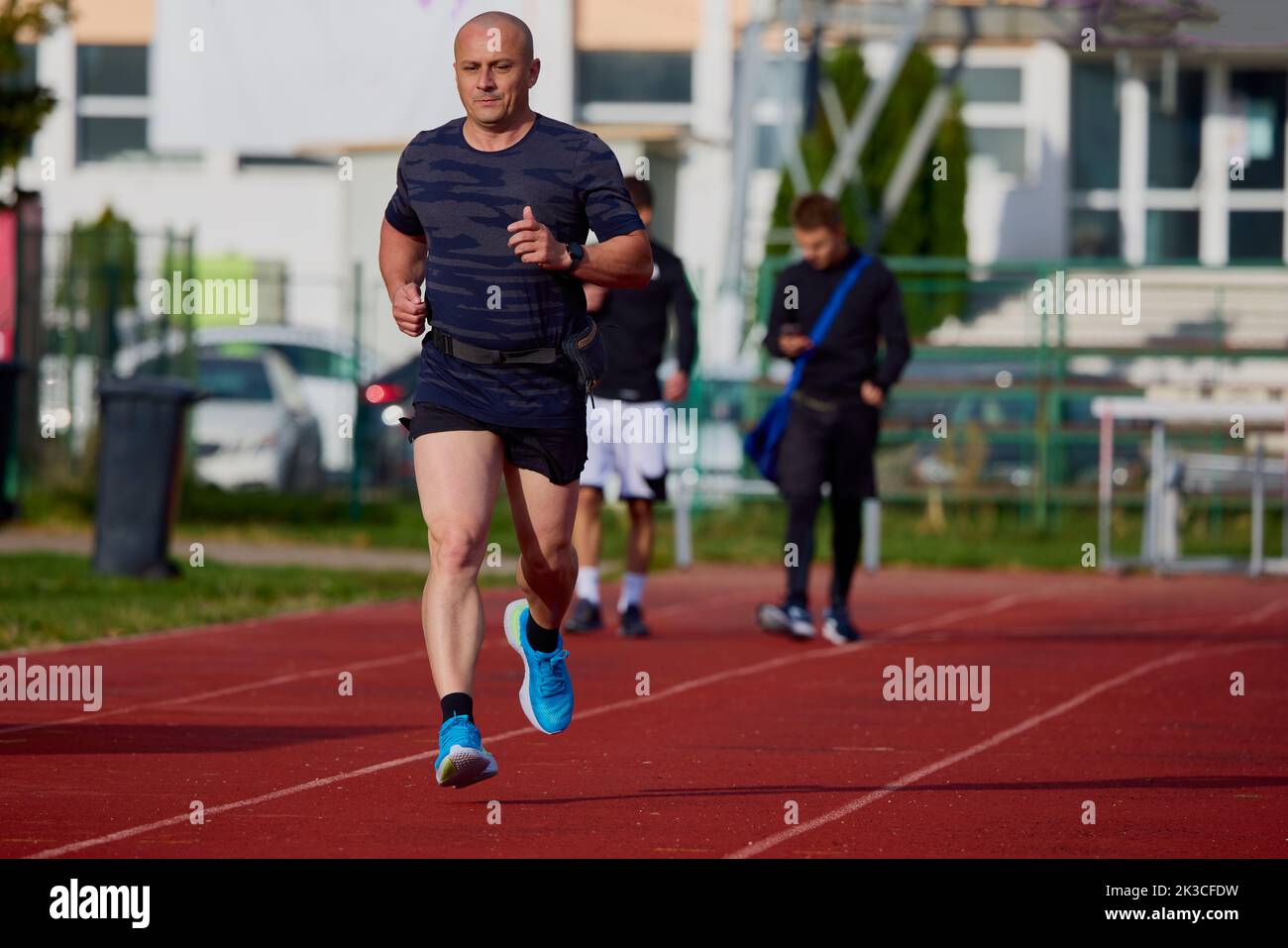 A man running on a running track Stock Photo - Alamy
