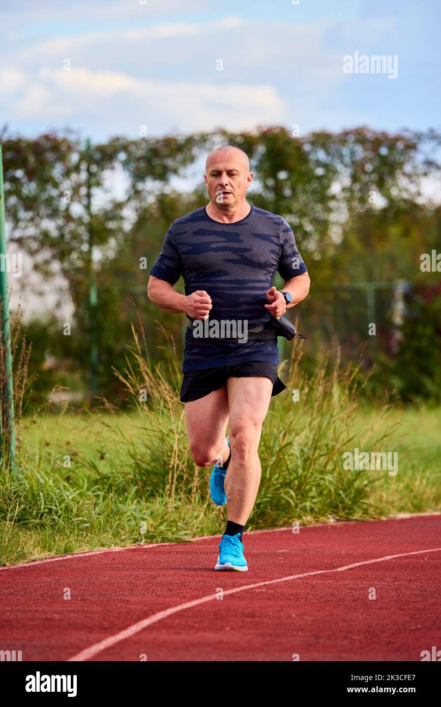 A man running on a running track Stock Photo - Alamy