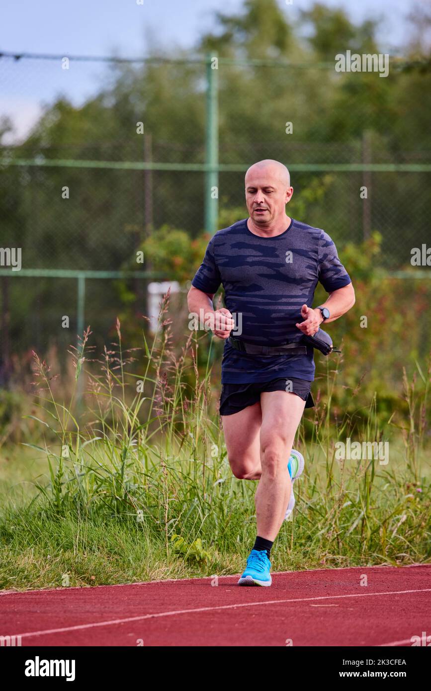 A man running on a running track Stock Photo - Alamy