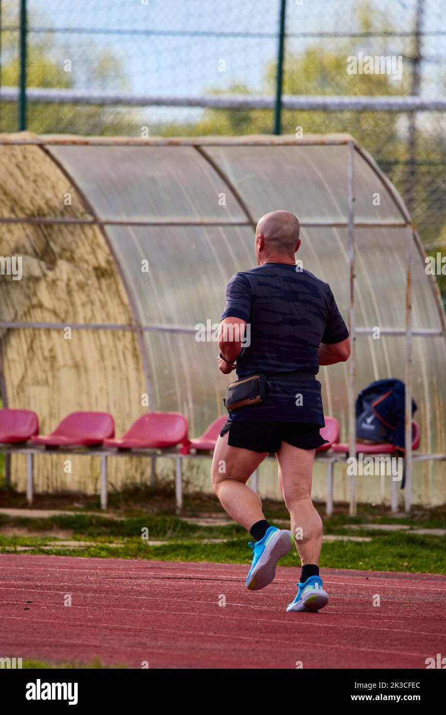 A man running on a running track Stock Photo - Alamy