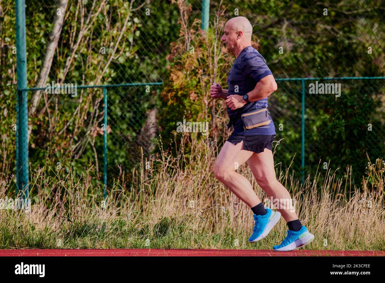 A man running on a running track Stock Photo - Alamy