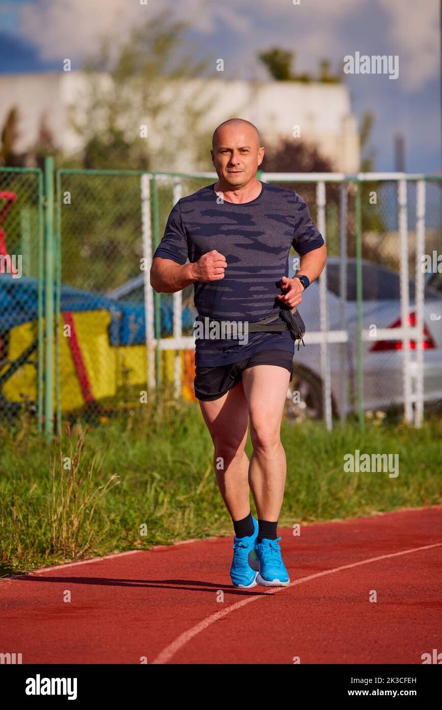 A man running on a running track Stock Photo - Alamy