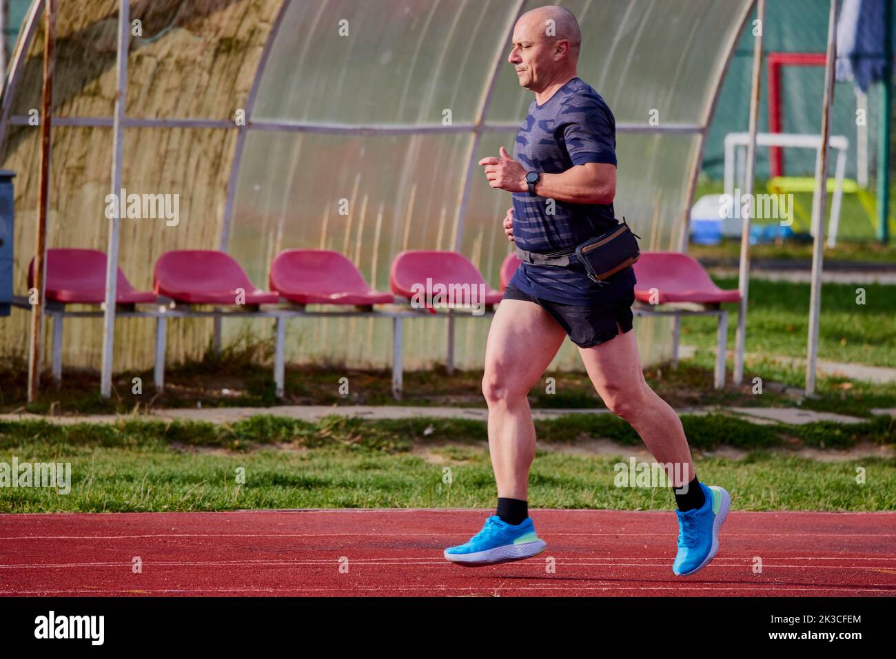 A man running on a running track Stock Photo - Alamy