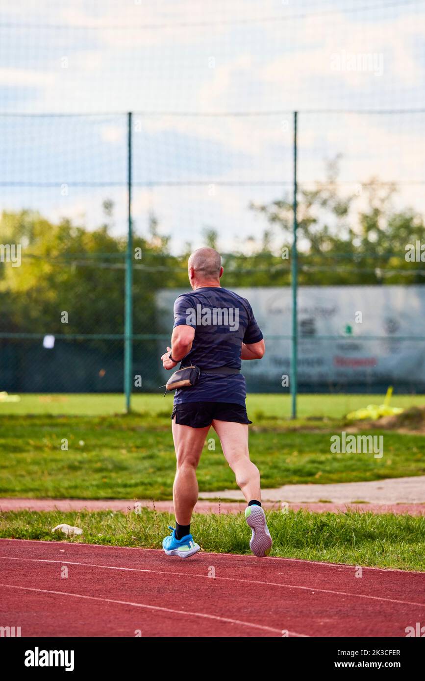 A man running on a running track Stock Photo - Alamy