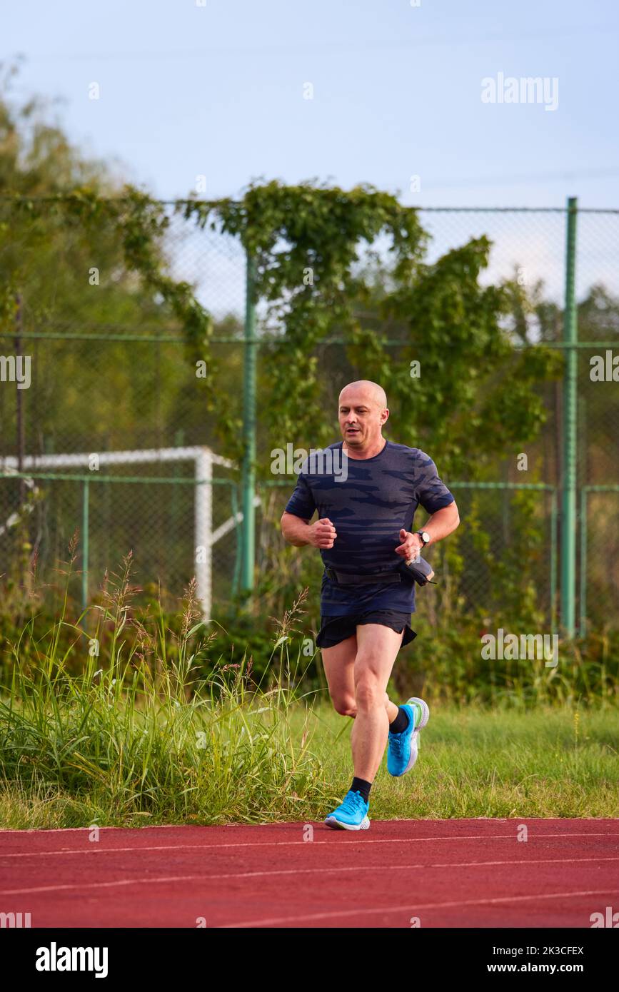 A man running on a running track Stock Photo - Alamy