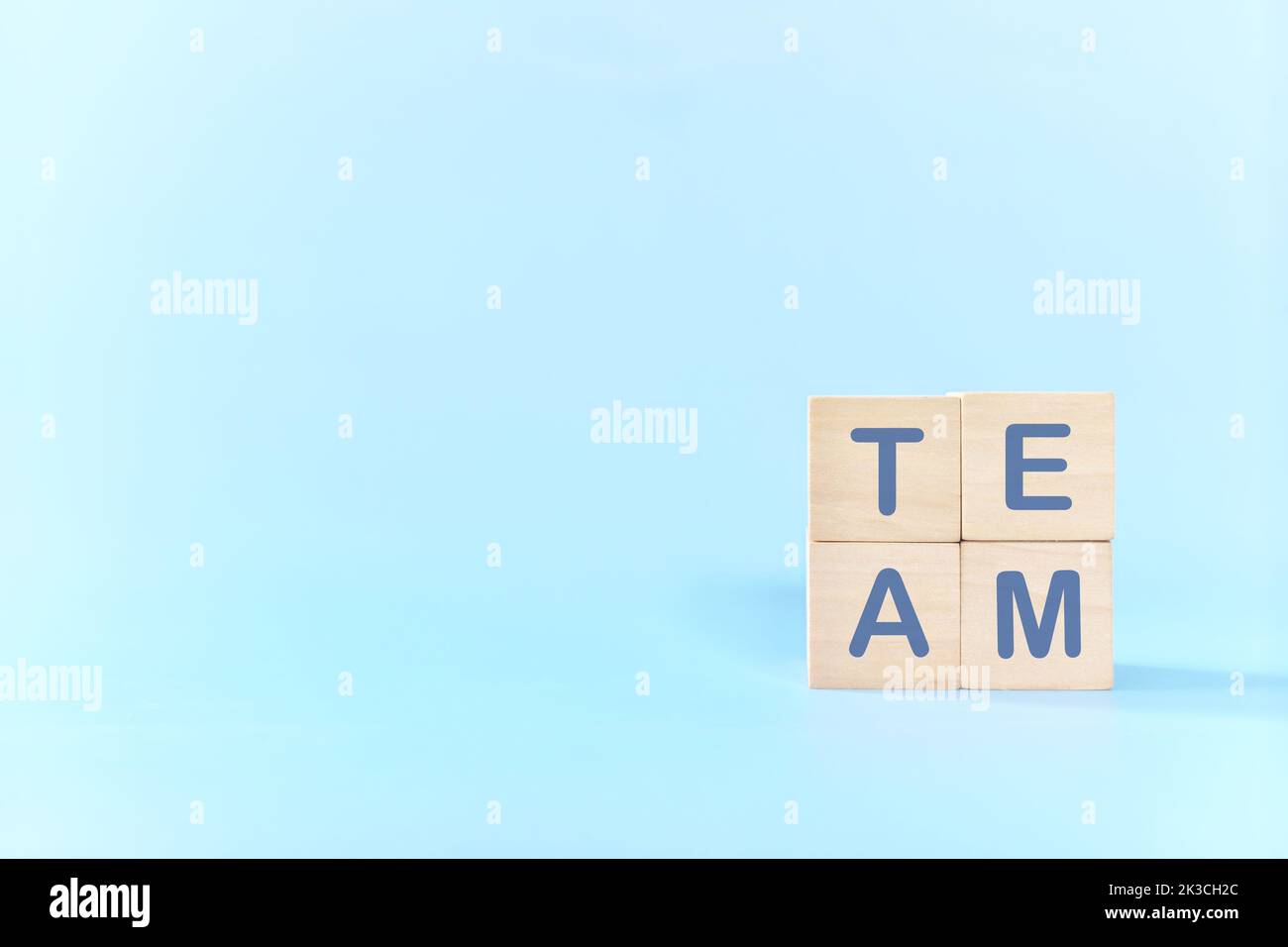 Teamwork and team building business concept. Hand putting together wooden blocks wood puzzle ...