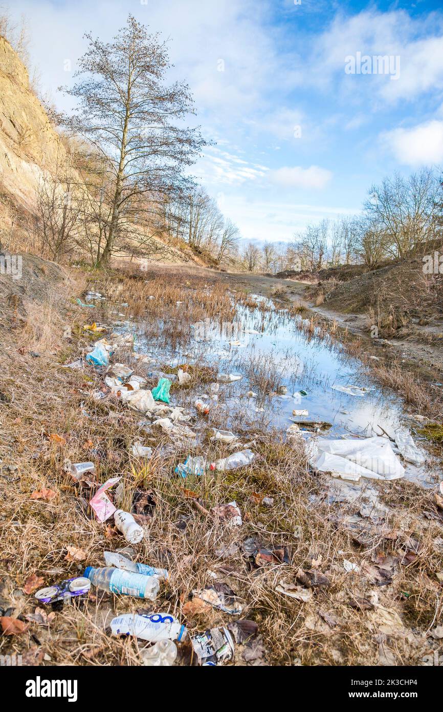 Plastic bottle and bag waste bag discarded at a UK quarry site Stock ...