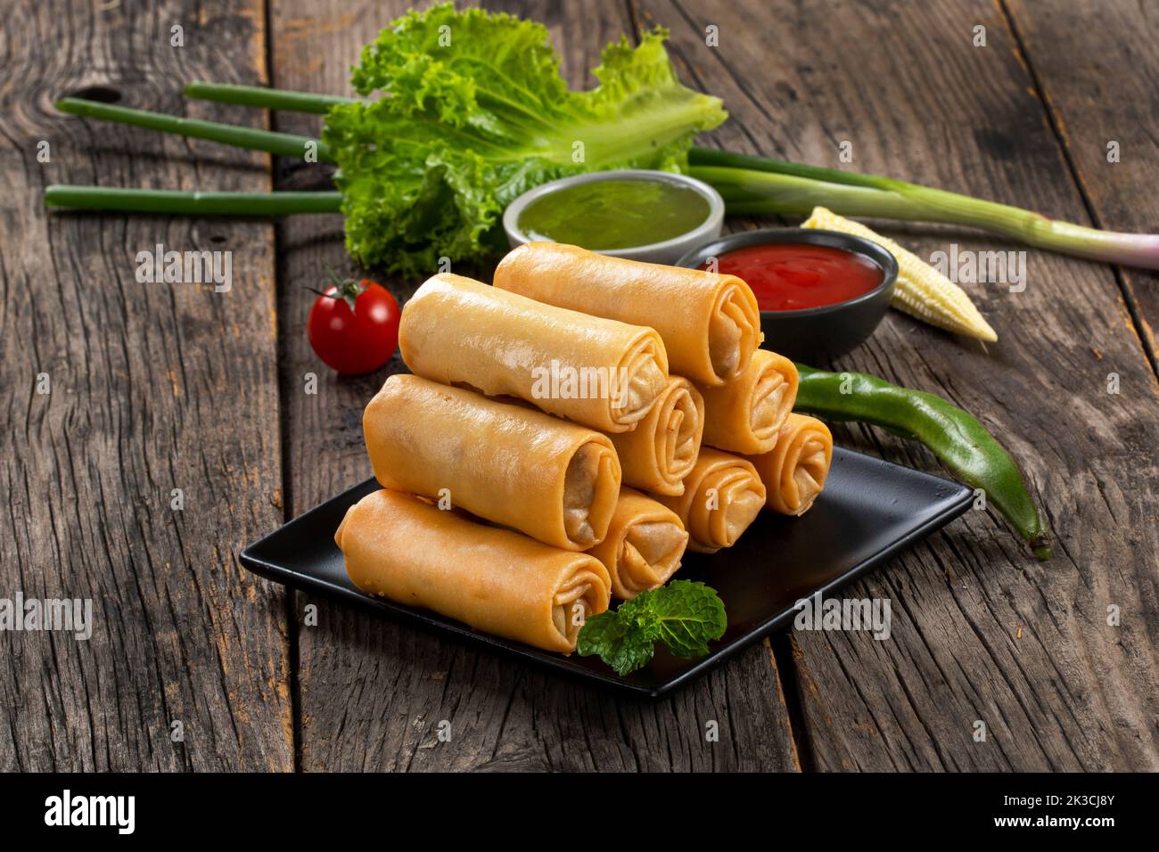 Fried spring rolls with sweet chili sauce and lime on plate Stock Photo ...