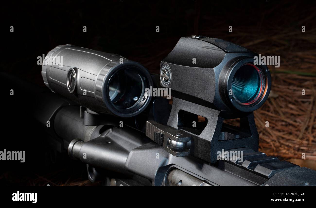 Magnifier swung from behind the red dot on an assault rifle Stock Photo ...