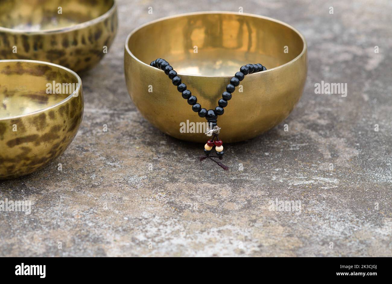 Tibetan Singing Bowls With Sticks On The Concrete Grey Background