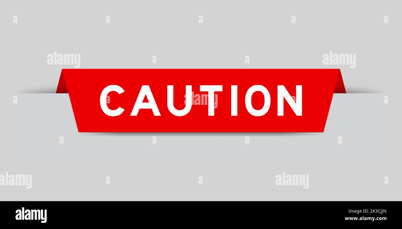Red color inserted label with word caution on gray background Stock ...