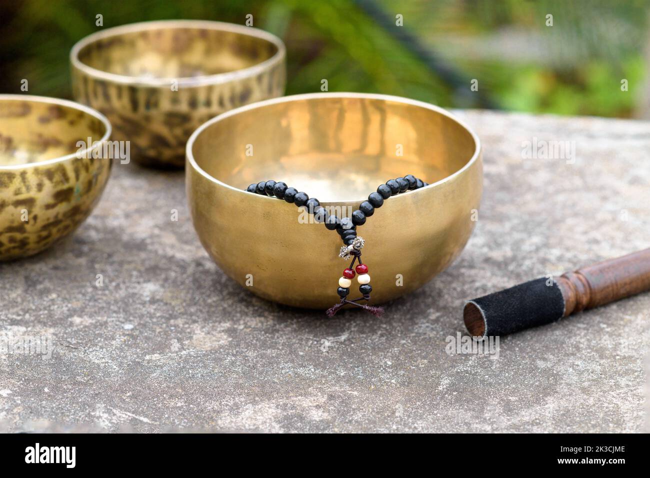 Tibetan singing bowls with sticks on the concrete grey background ...