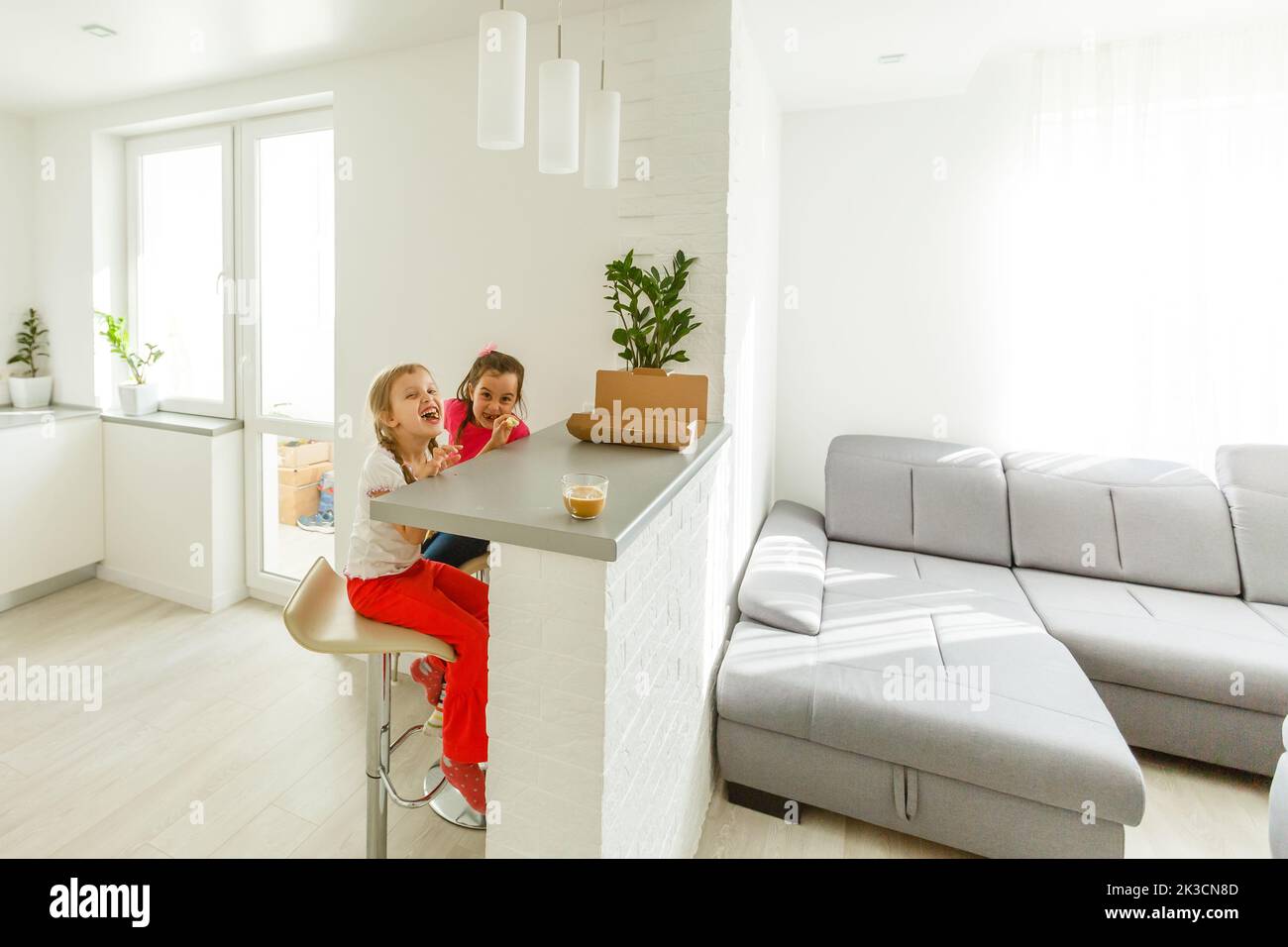 Two little girls eating curd and chatting Stock Photo - Alamy