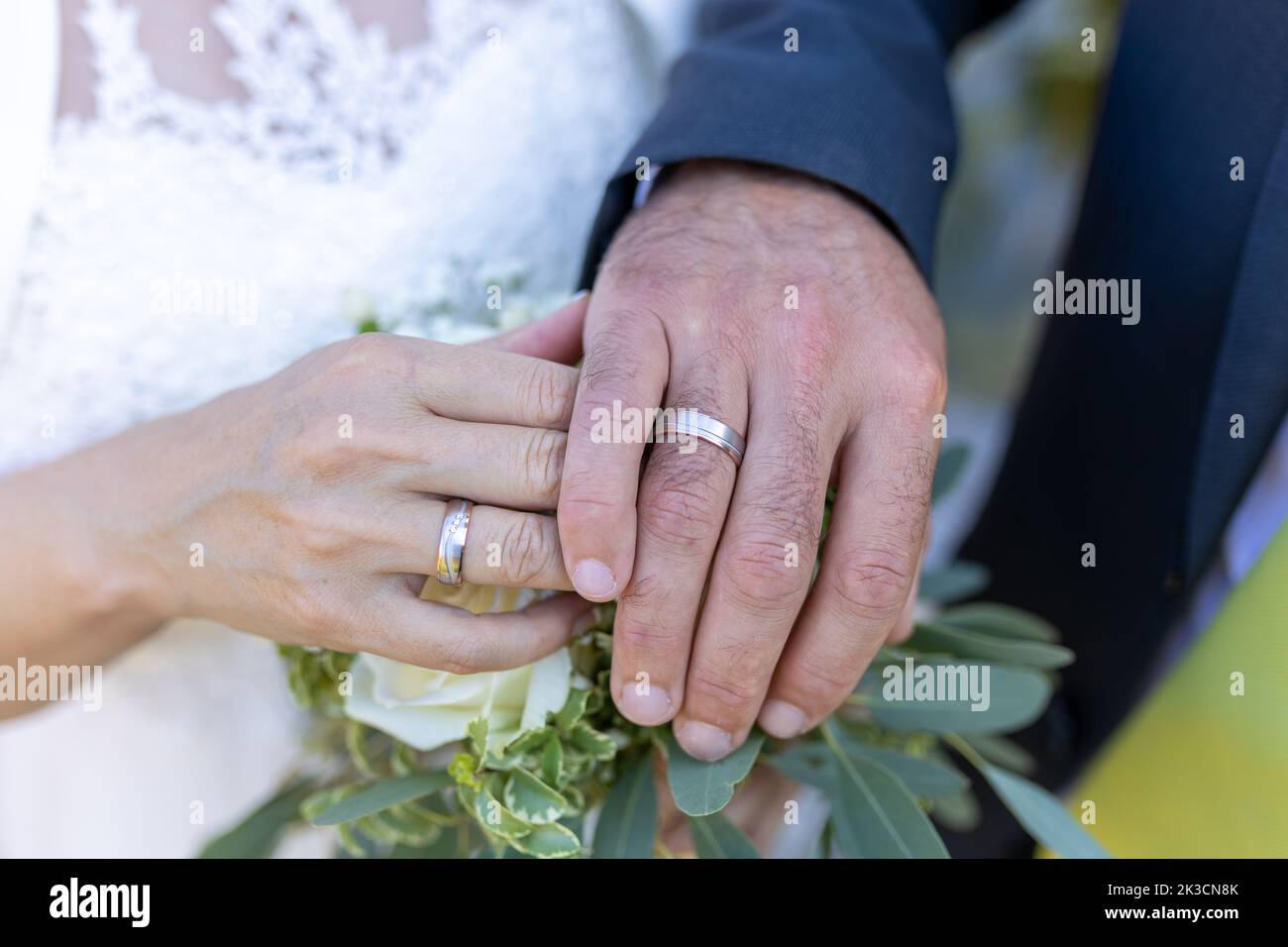 A close-up shot of wedding rings on the bride's and groom's hands Stock ...