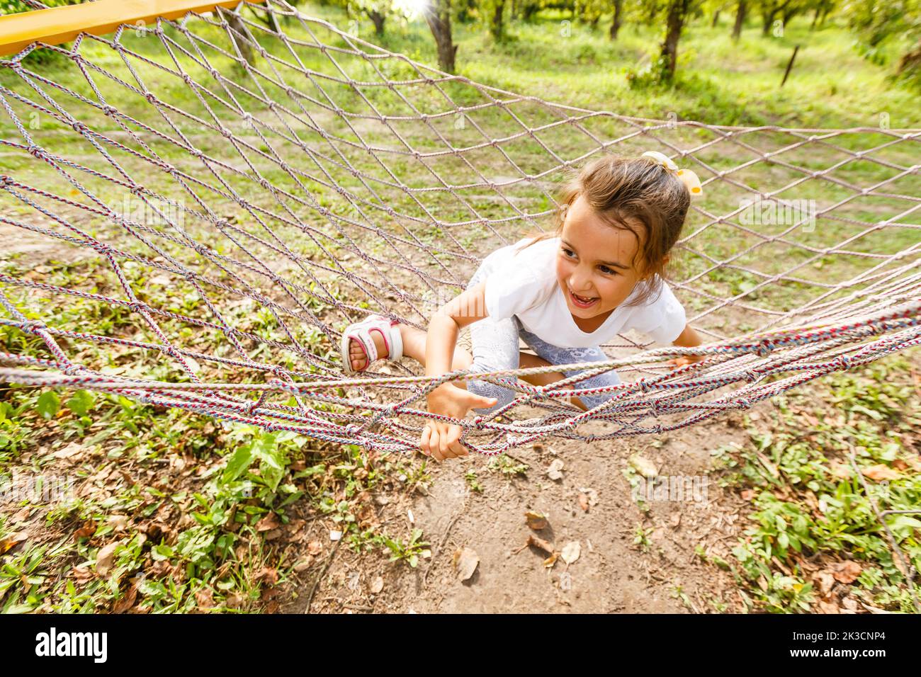 Happy Child Lying in Hammock. Cute Smiling Little Girl rides in Hammock ...