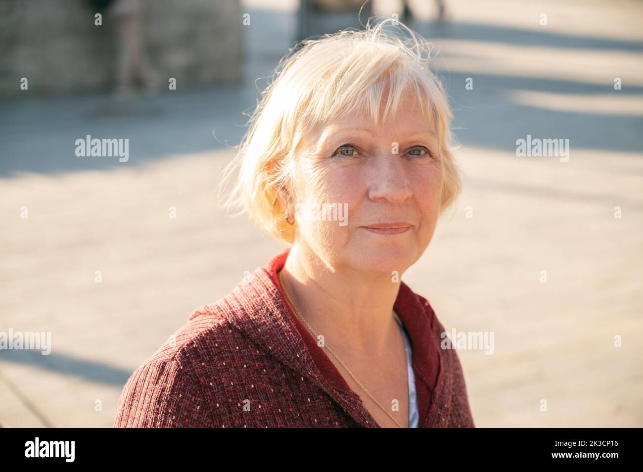 Portrait of beautiful aged woman in the street. Selective soft focus on ...