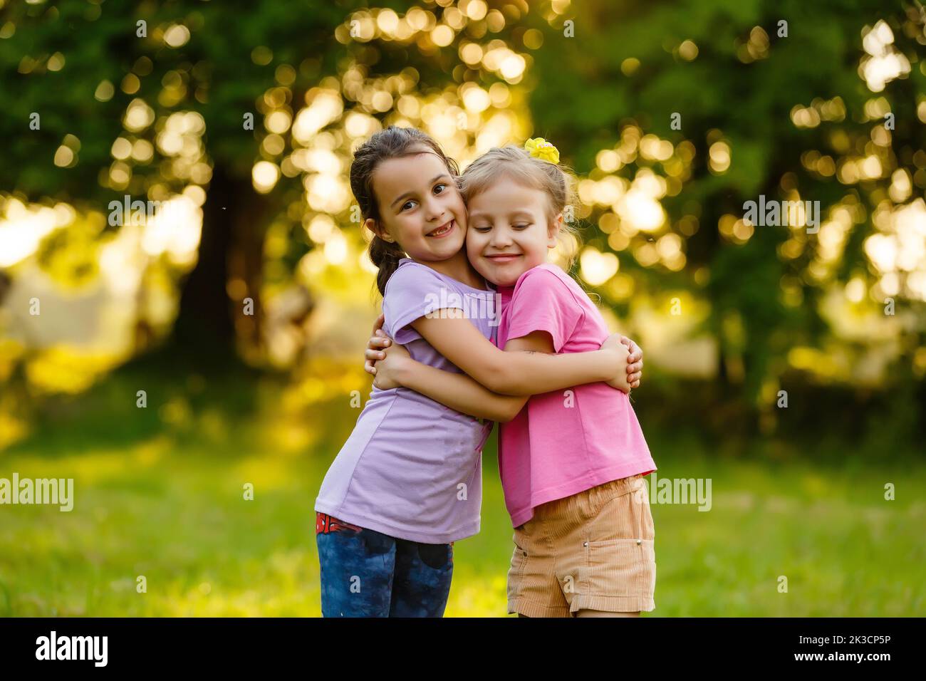 two little girls walking in the field Stock Photo - Alamy