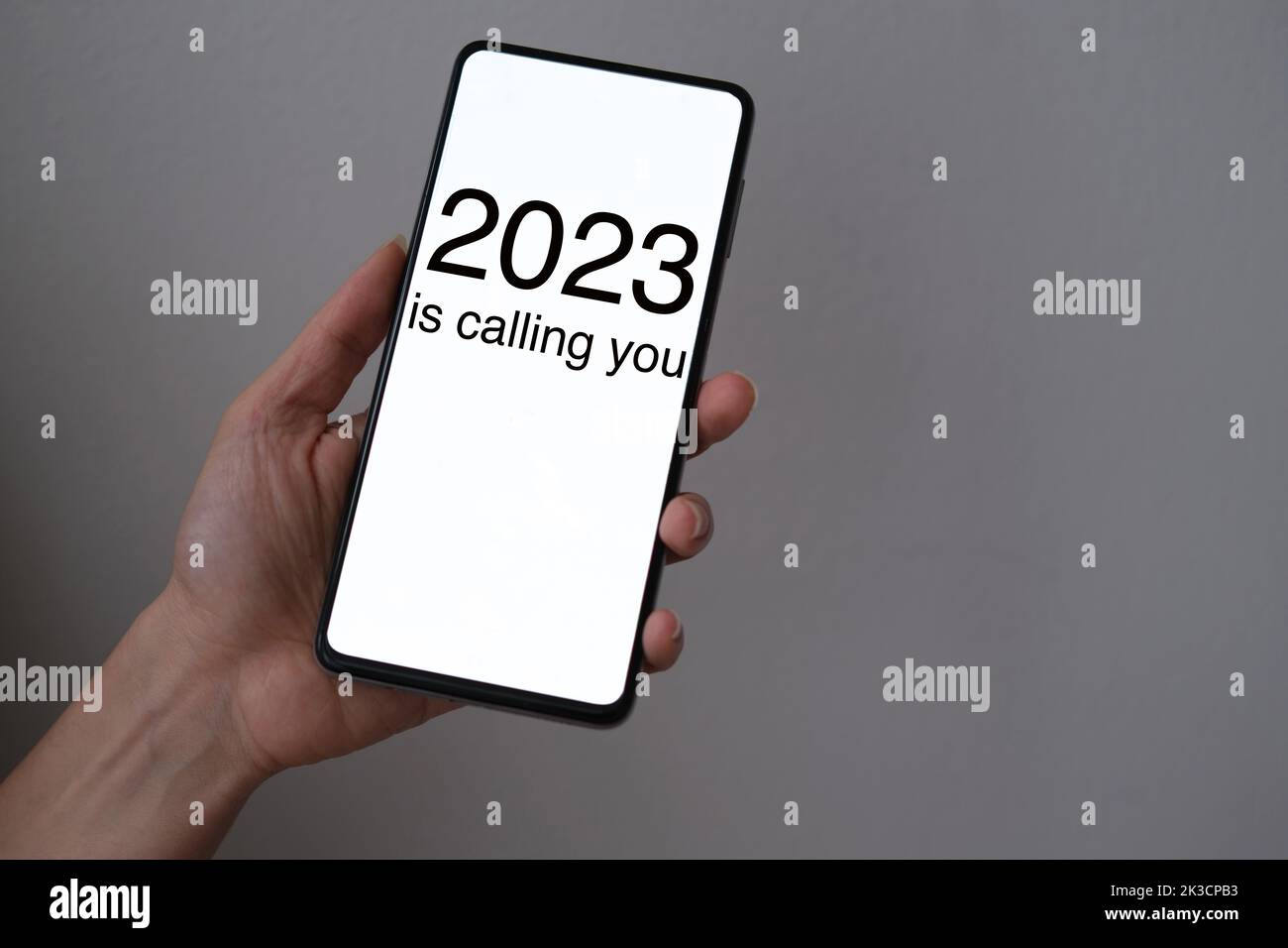 2023 Is Calling You. Happy New Year 2023 concept with hand holding a ...