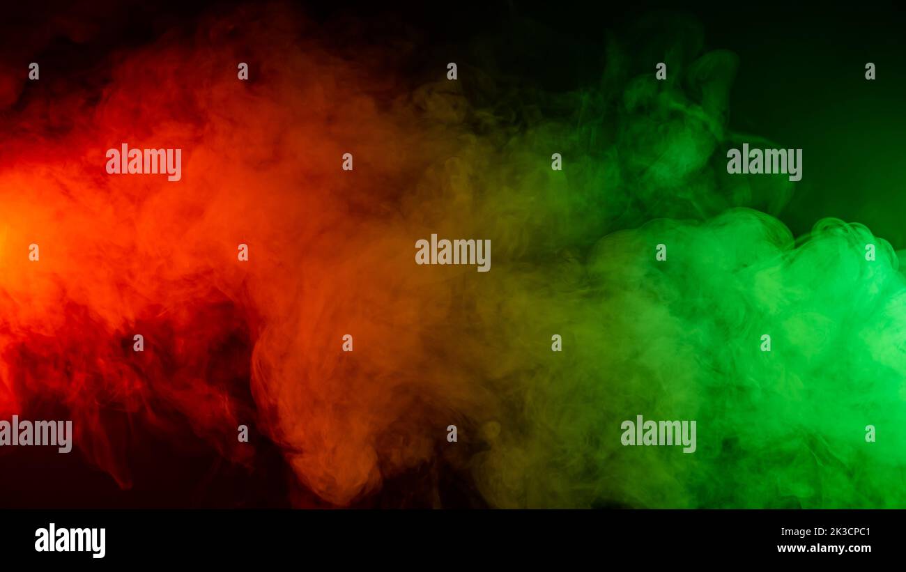 Red green smoke on a black background Stock Photo - Alamy